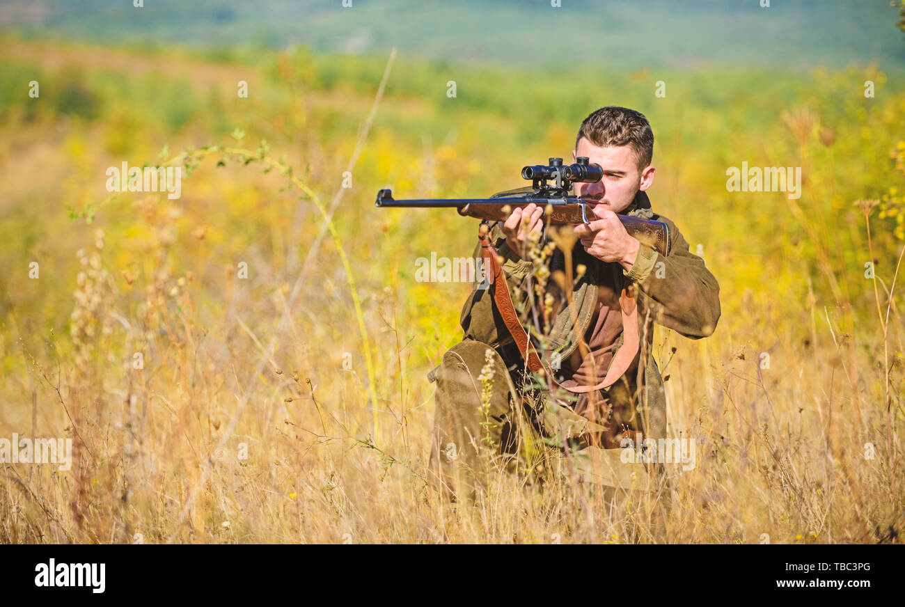 Man hunter aiming rifle nature background. Experience and practice ...