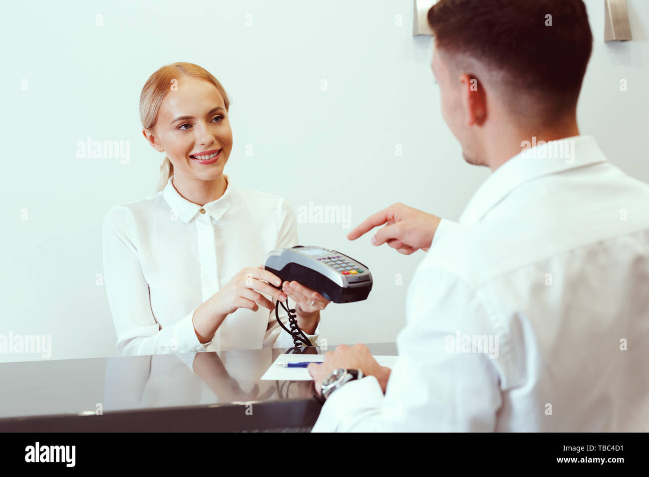 Businessman arriving at reception desk hi-res stock photography and ...