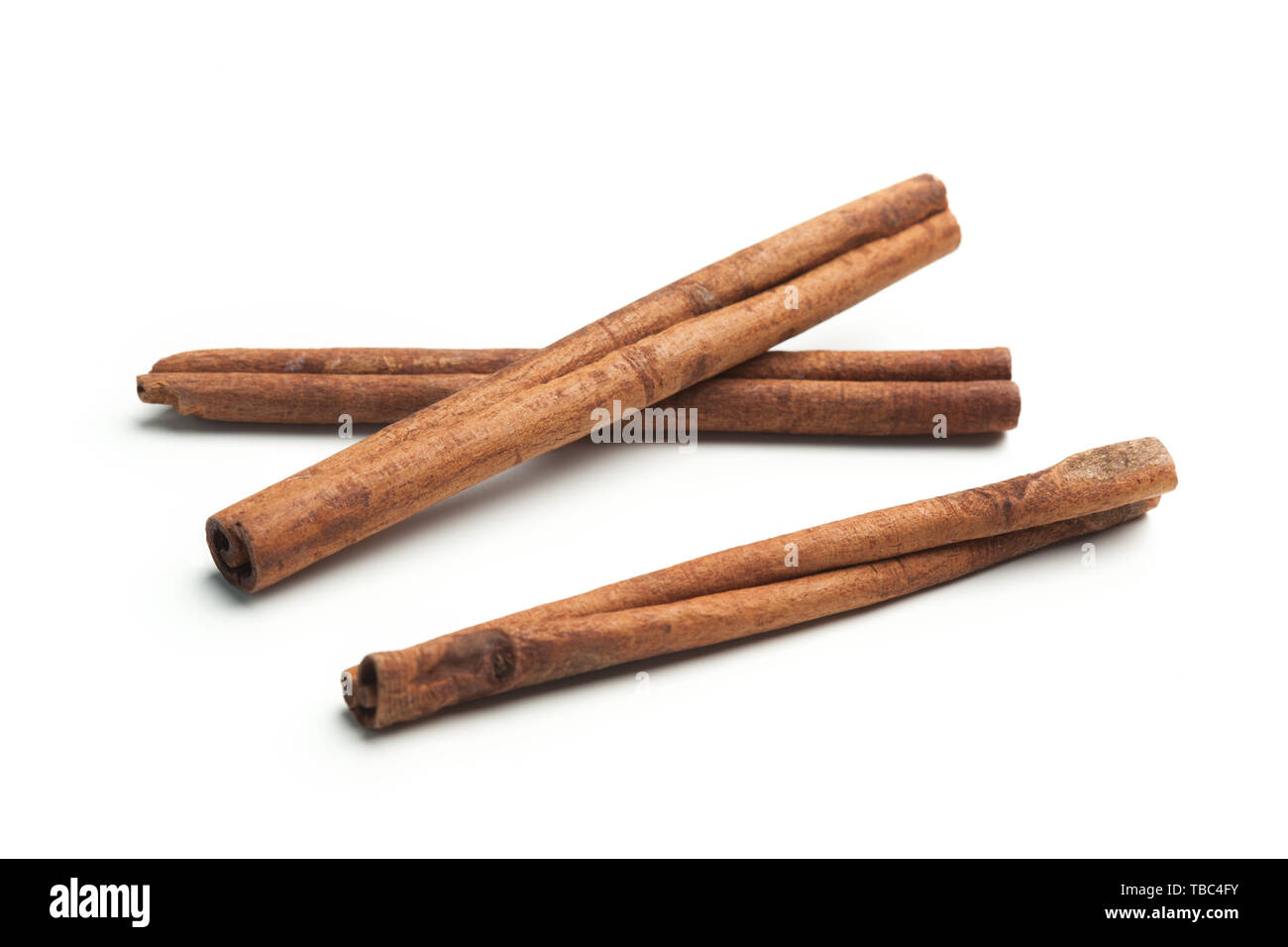 Cinnamon sticks on white background Stock Photo - Alamy