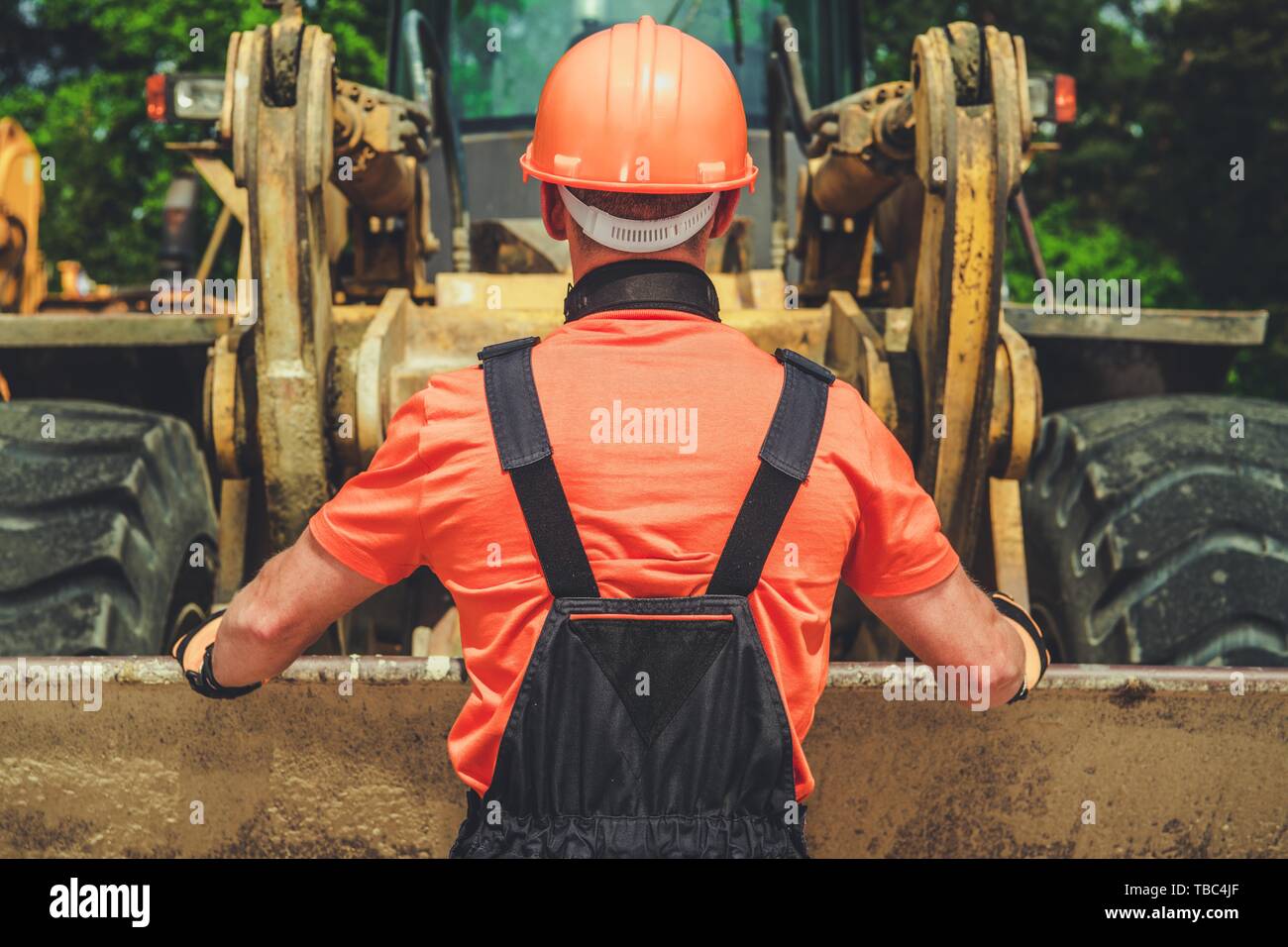 Worker and the Bulldozer. Caucasian Heavy Duty Equipment Operator in ...