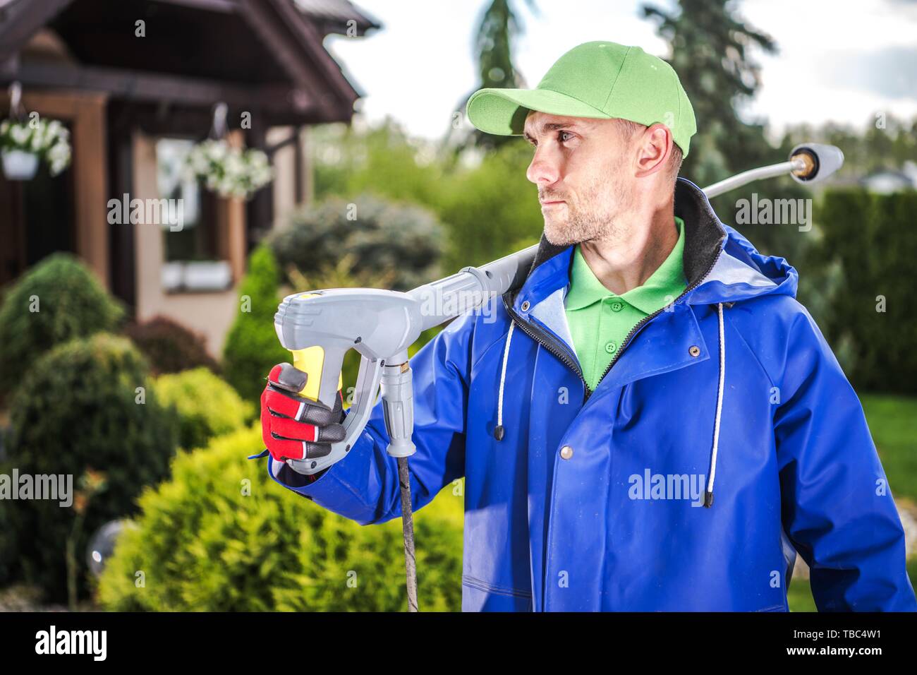 Pressure Cleaning Time. Caucasian Men Wearing Blue Industrial Rain Coat ...