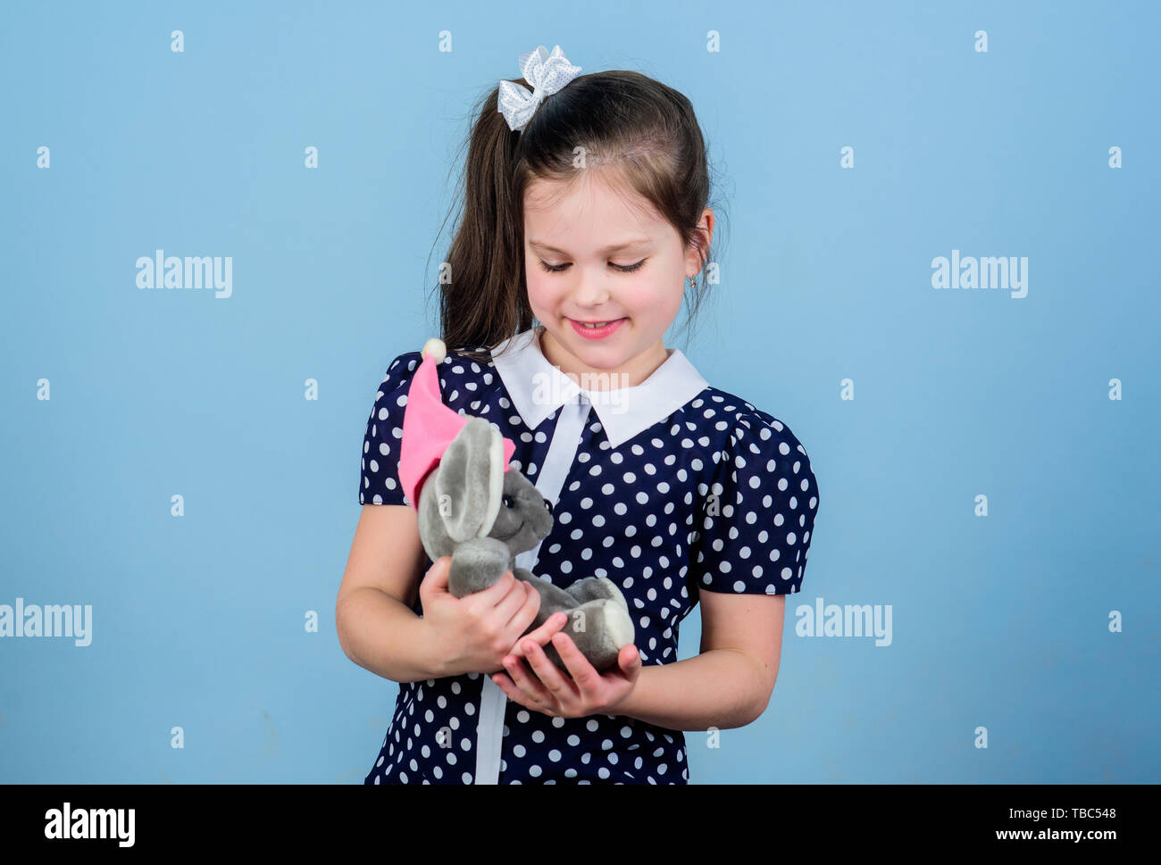 Spreading love. Kid cute girl play with soft toy mouse. Happy childhood ...