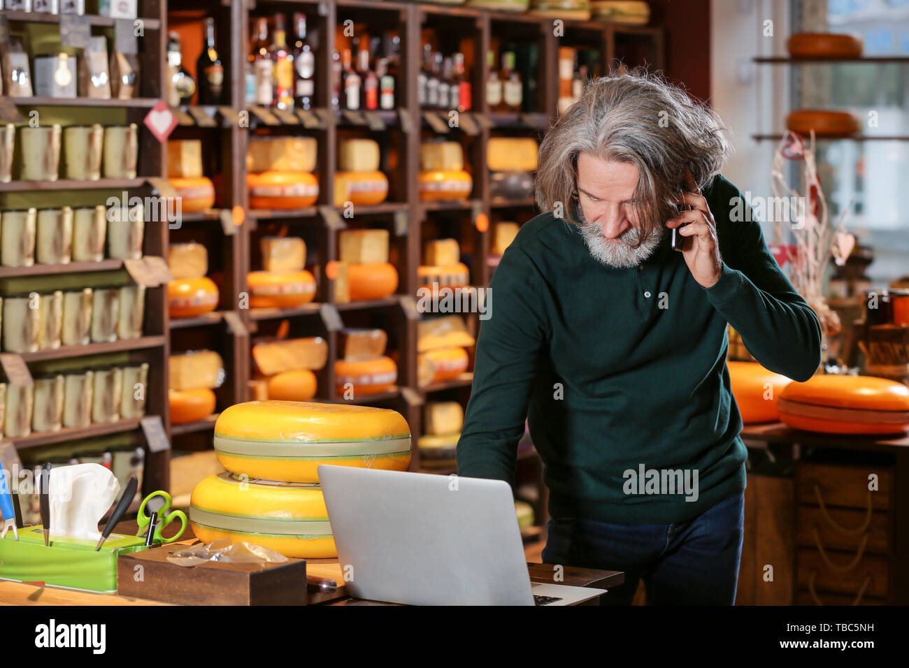 Business owner ordering goods for his store Stock Photo - Alamy