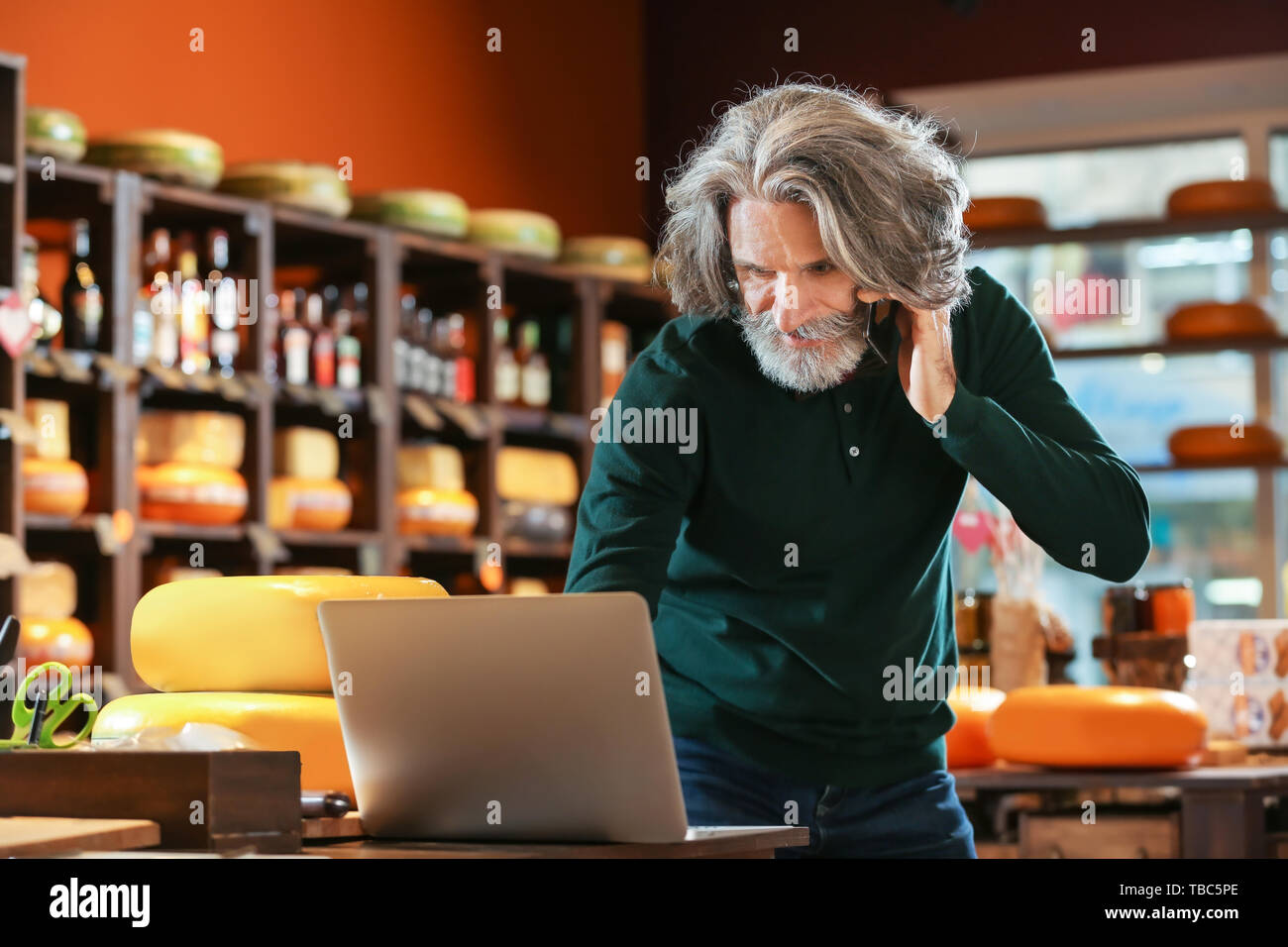 Business owner ordering goods for his store Stock Photo - Alamy