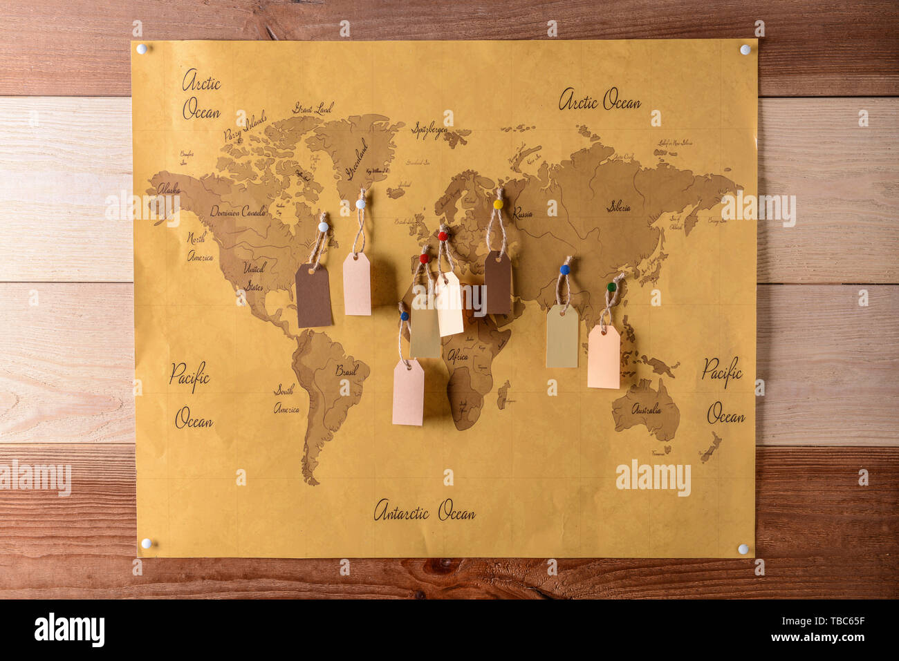 World map with tags on wooden wall Stock Photo - Alamy