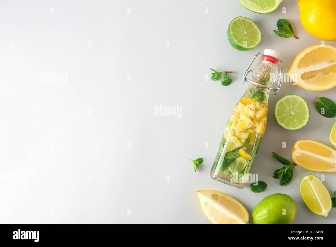 Bottle of infused water and fruits on white background Stock Photo - Alamy