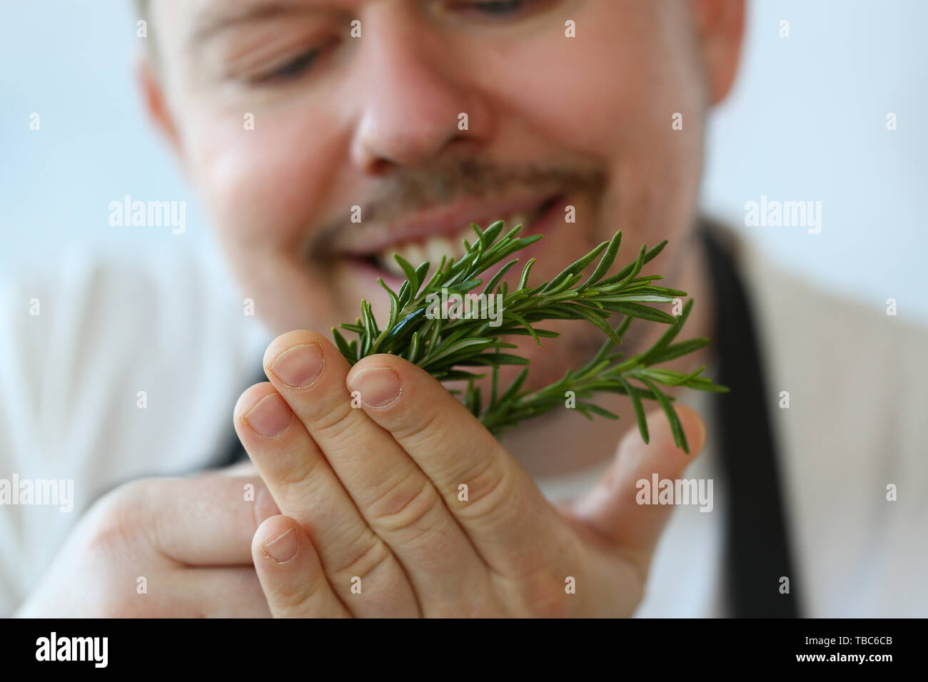 Smiling Chef Holding Green Rosemary Herb Bunch Stock Photo - Alamy