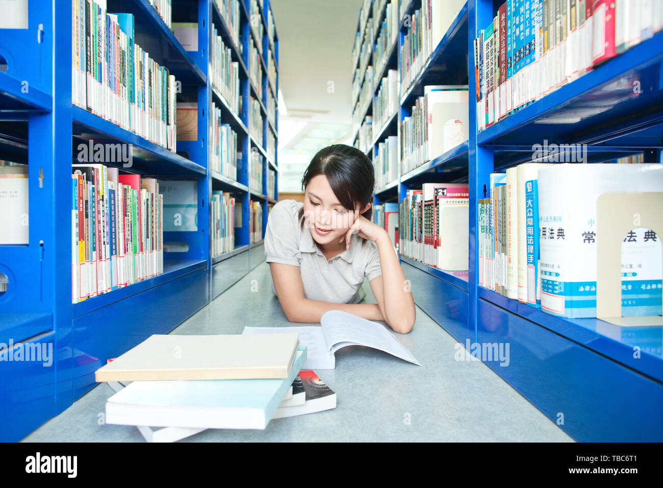 Studying in the library Stock Photo - Alamy