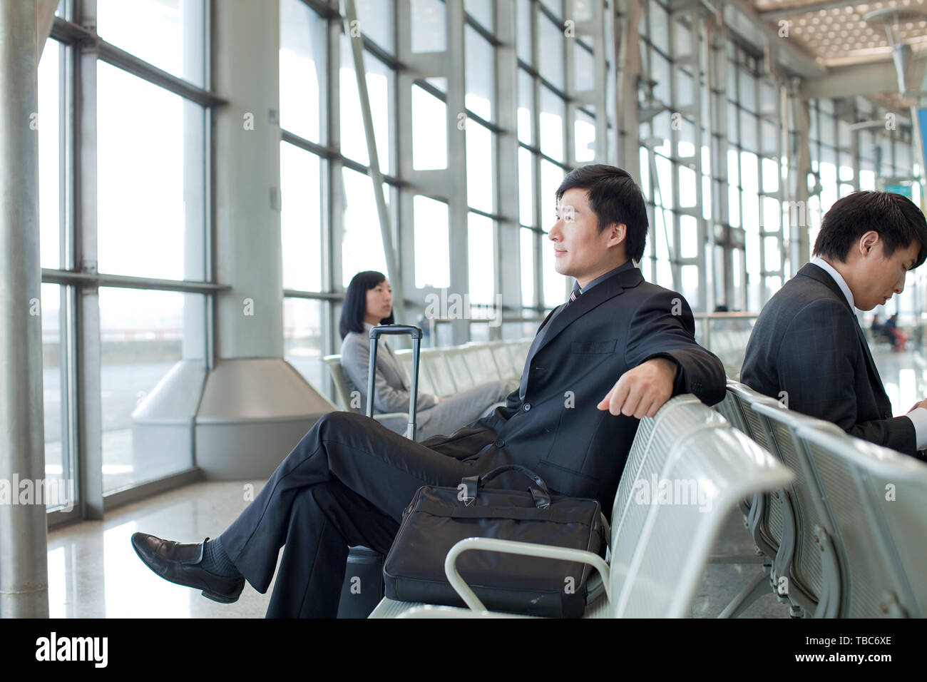 Young man sitting waiting hi-res stock photography and images - Alamy