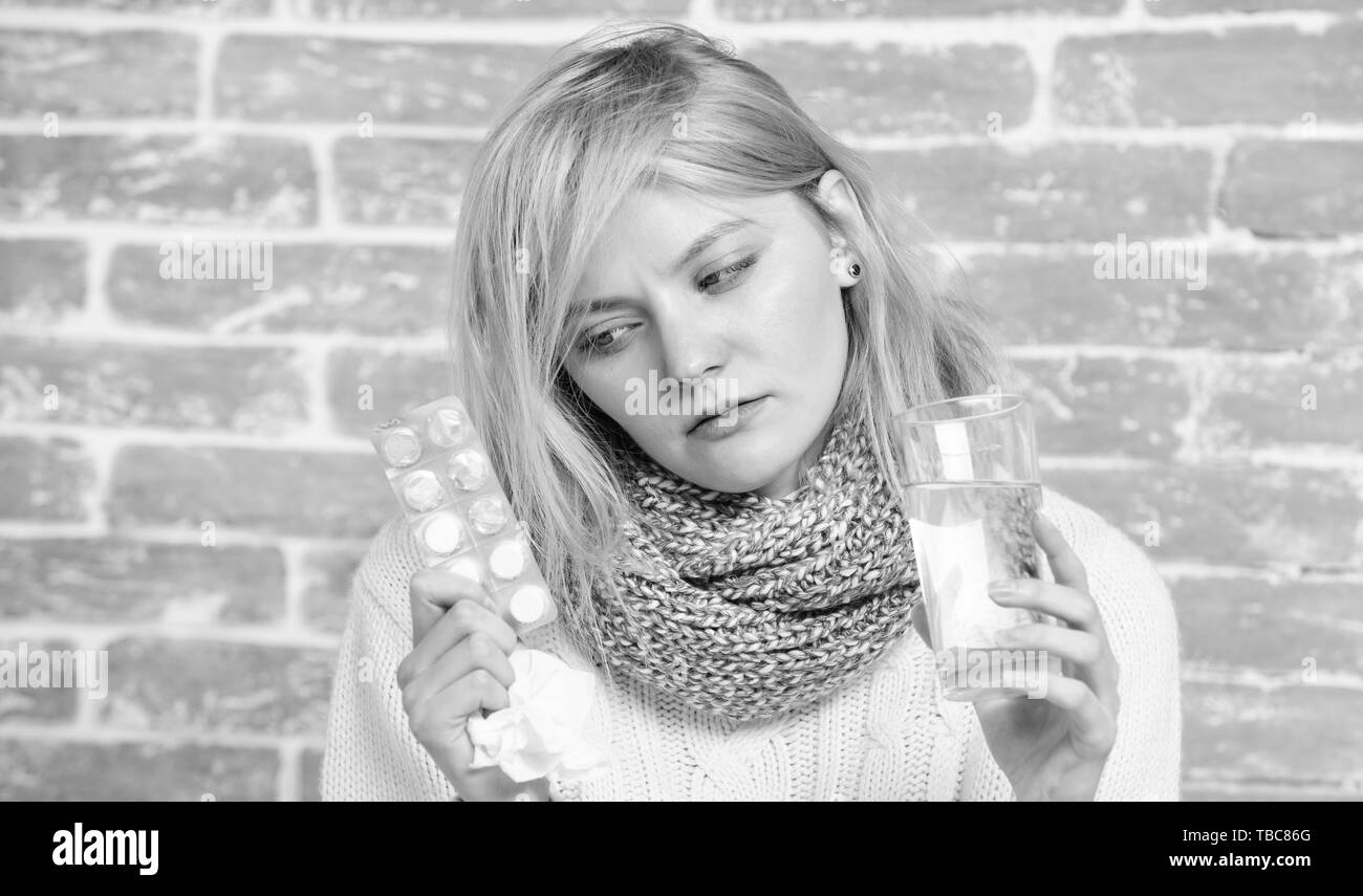 When a cold becomes more serious. Unhealthy woman holding pills and ...