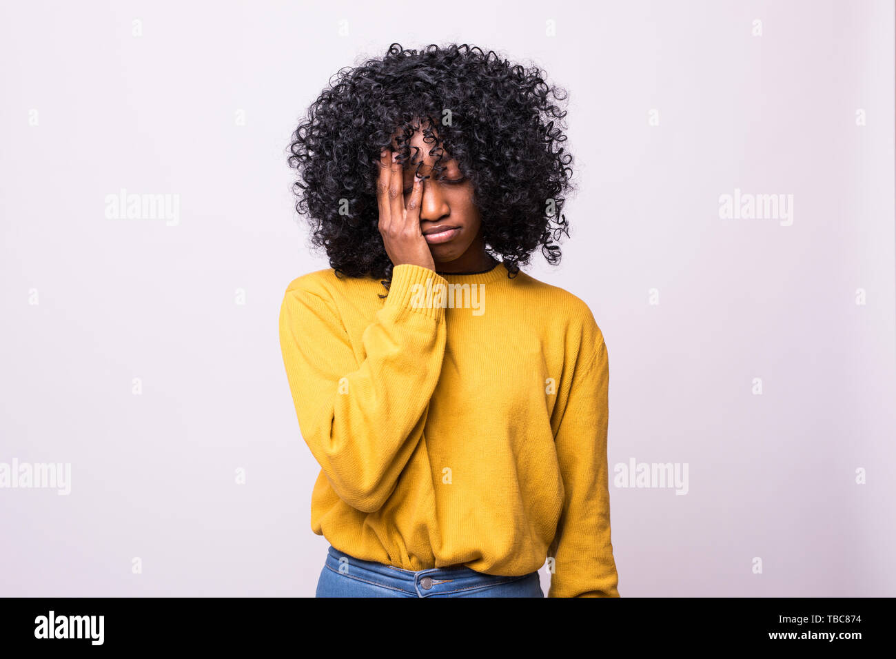 Sad pretty girl feeling upset while spending time at home alone ...