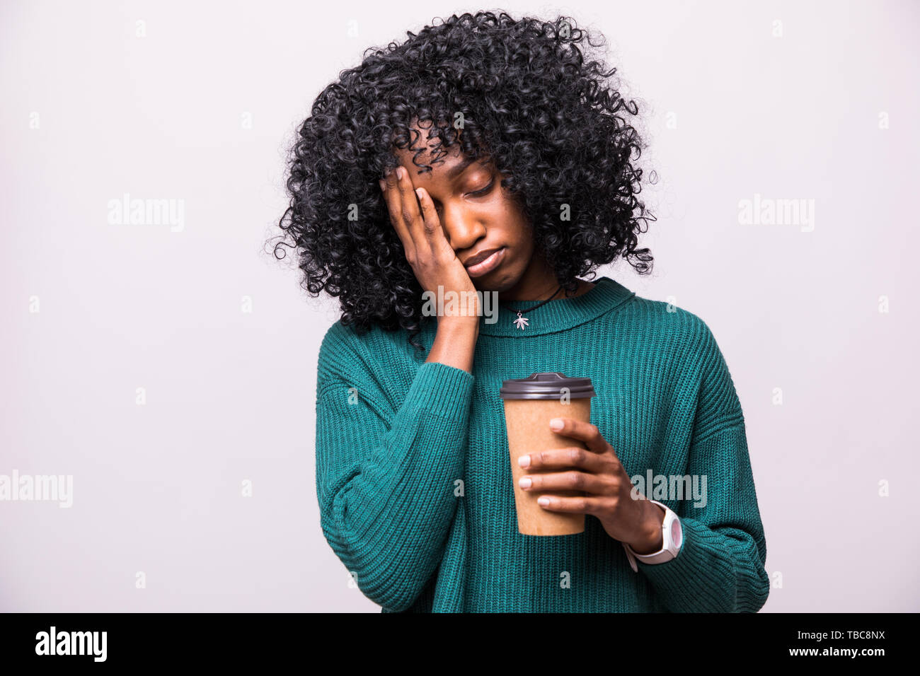 Tired sleepy african woman covers half of face with palm, has sad ...