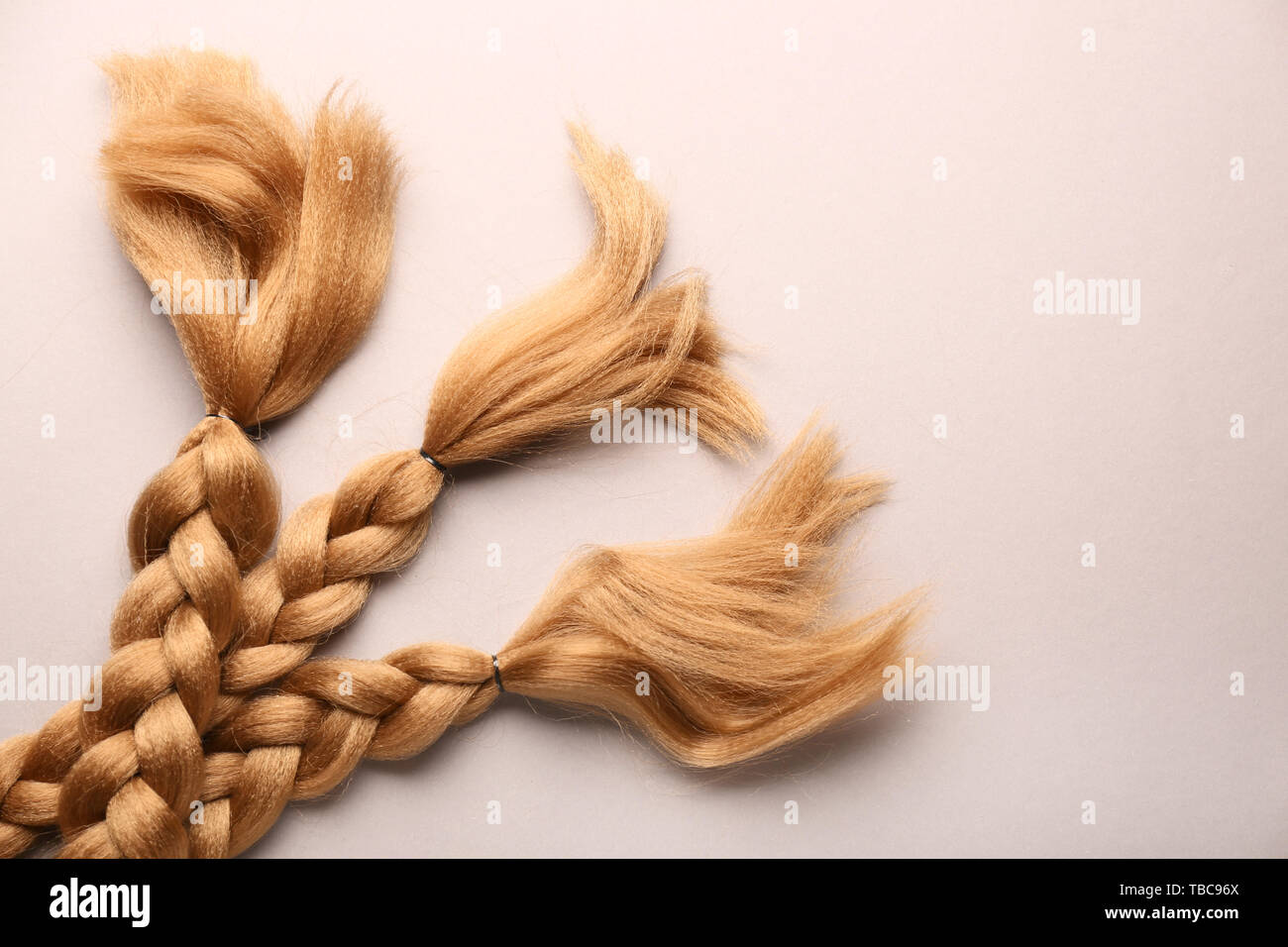 Braided strands on light background. Concept of hair donation Stock ...