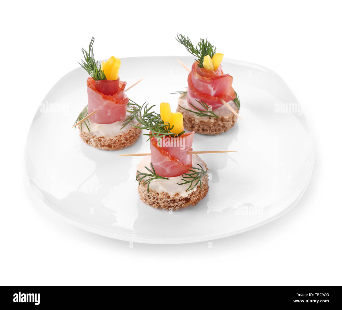 Plate with tasty canapes on white background Stock Photo - Alamy