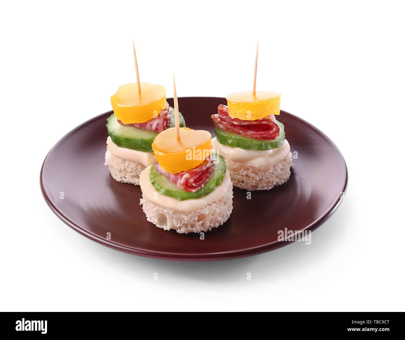 Plate with tasty canapes on white background Stock Photo - Alamy