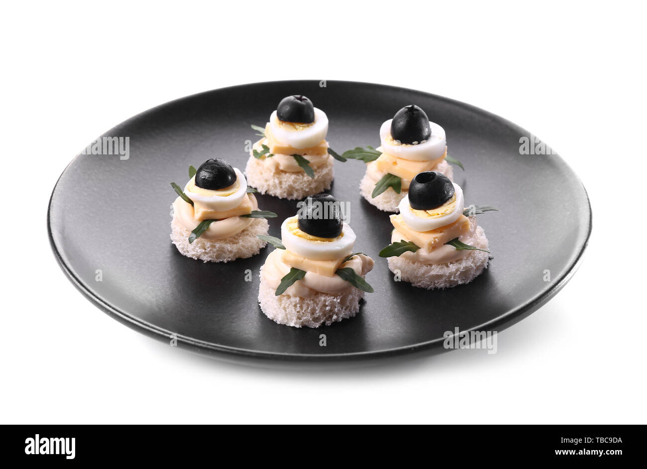 Plate with tasty canapes on white background Stock Photo - Alamy
