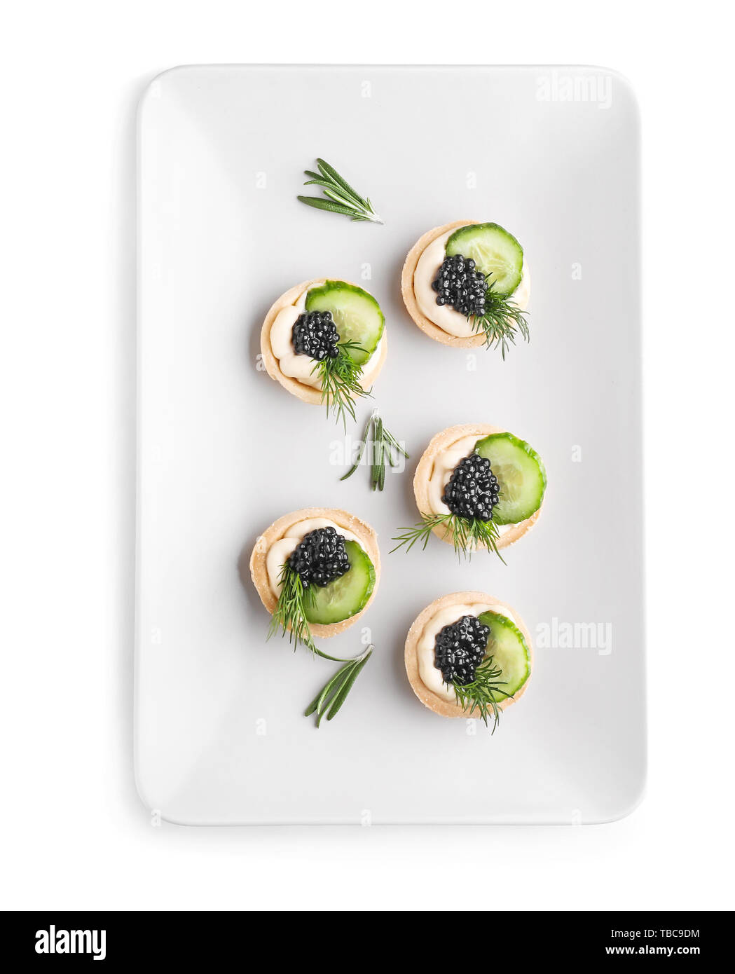 Plate with tasty canapes on white background Stock Photo - Alamy