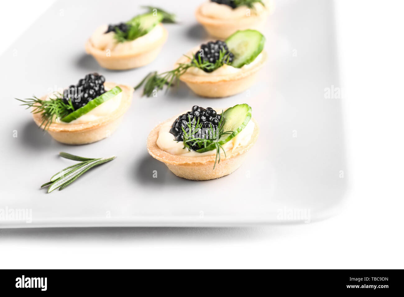 Plate with tasty canapes on white background, closeup Stock Photo - Alamy