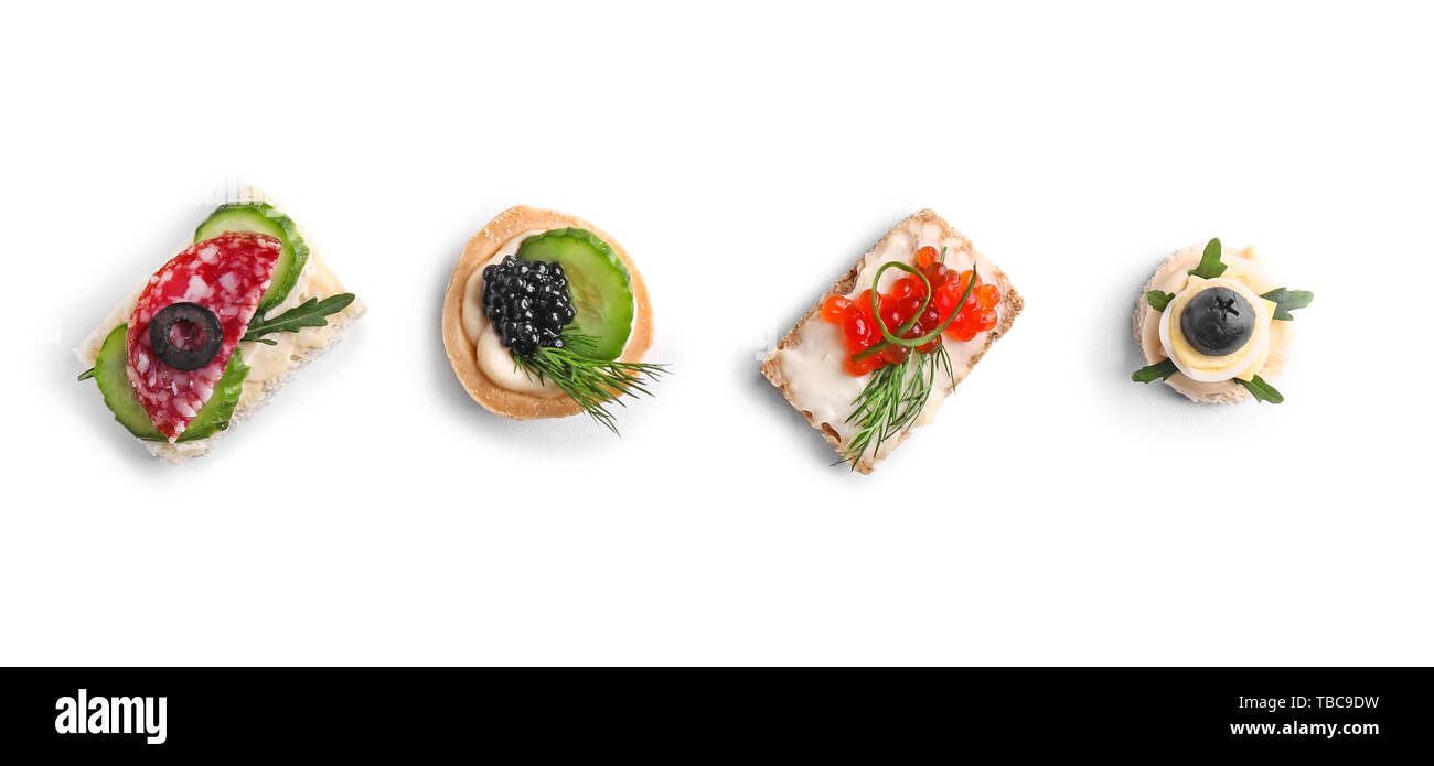 Assortment of tasty canapes on white background Stock Photo - Alamy