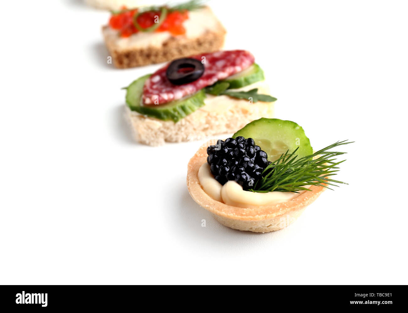 Assortment of tasty canapes on white background Stock Photo - Alamy
