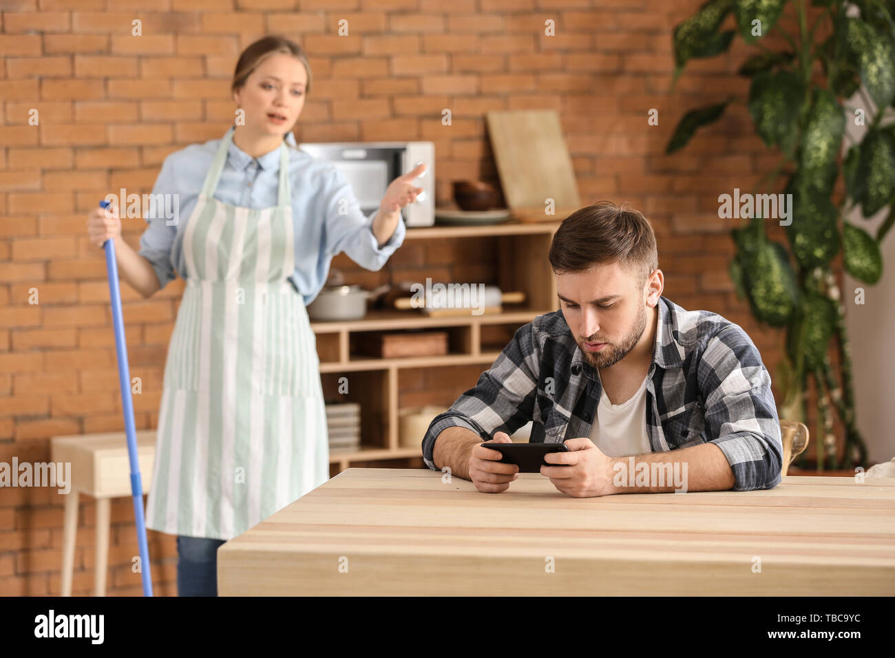 Woman cleaning man lazy hi-res stock photography and images - Alamy