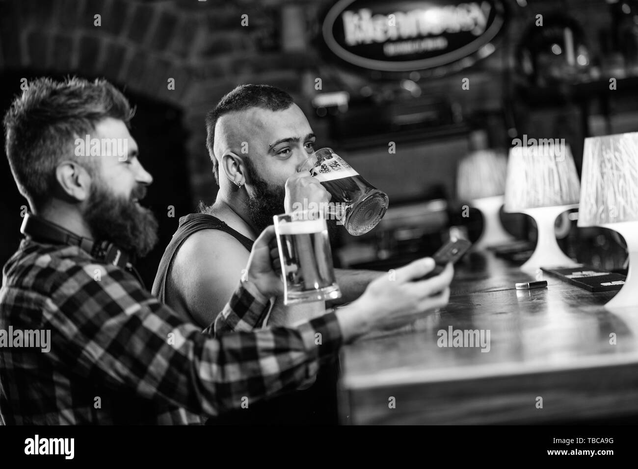 Men drinking beer together. Hipster brutal man drinking beer with ...