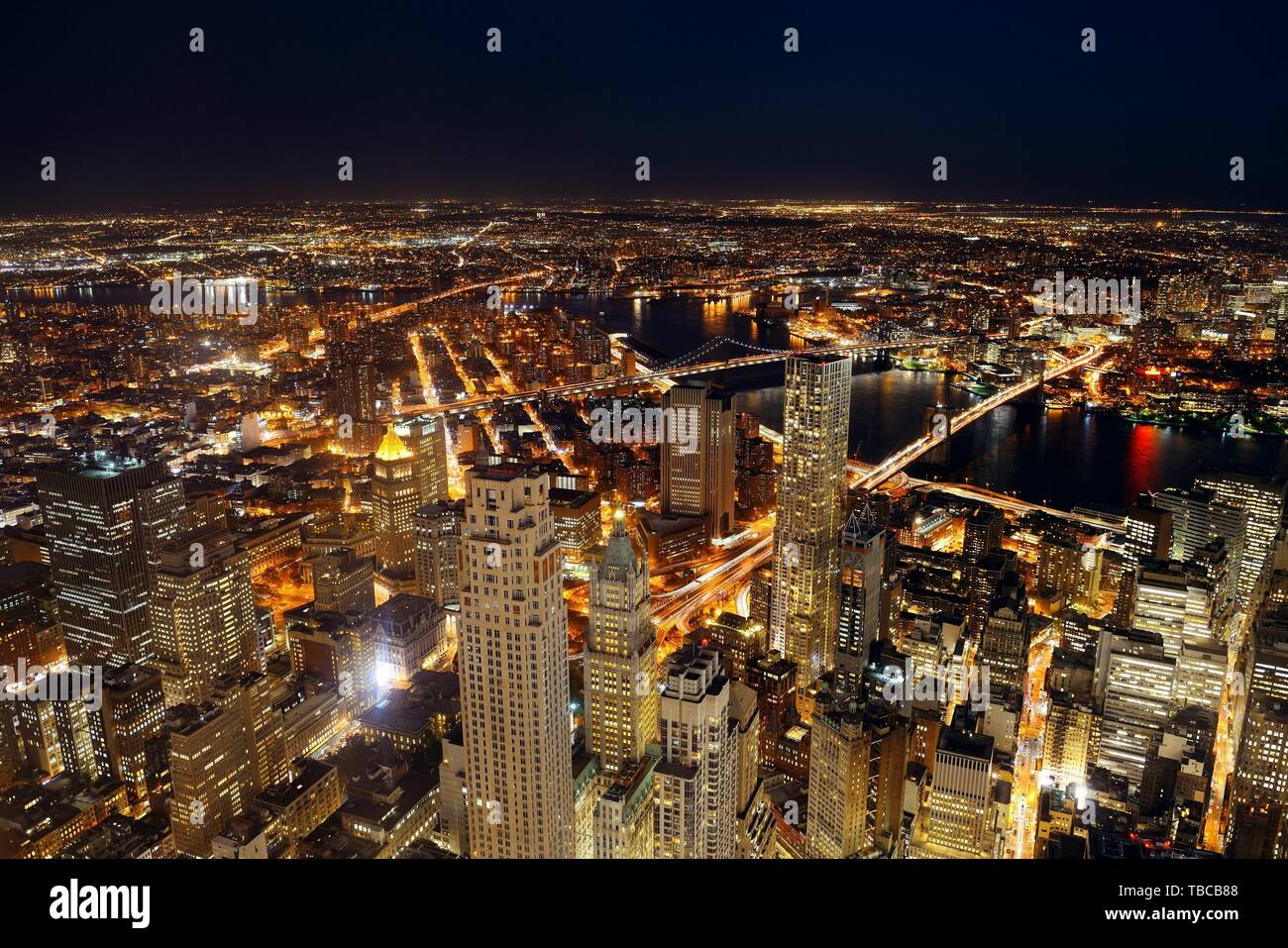 Rooftop night view of New York City downtown with urban skyscrapers ...