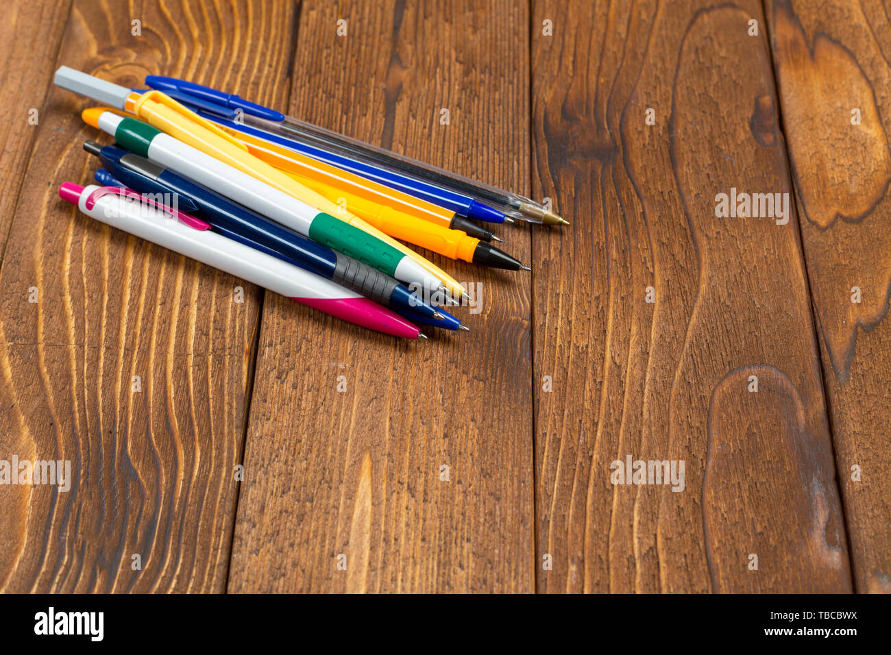different pens on wooden background Stock Photo - Alamy