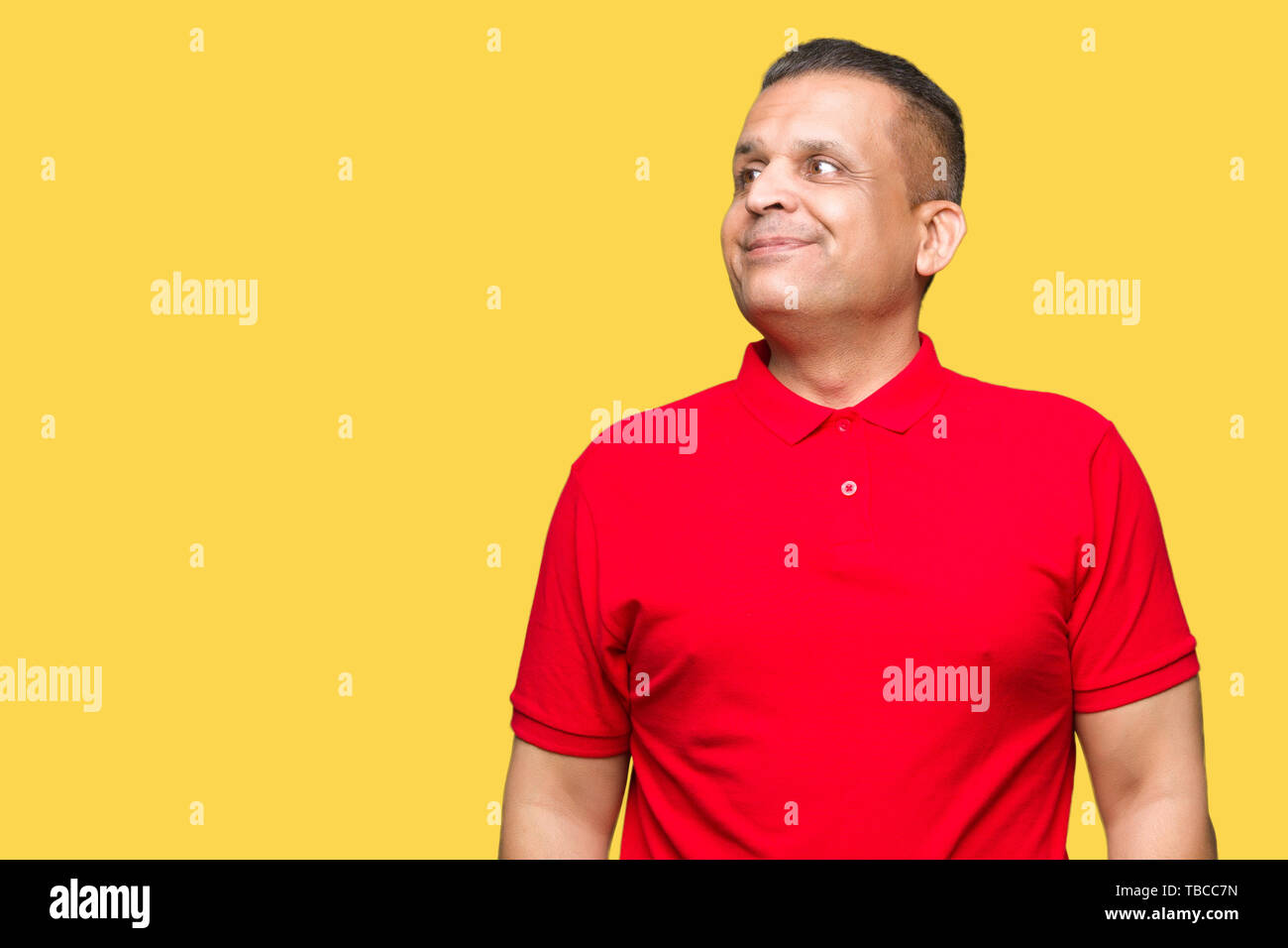 Middle age arab man over isolated background smiling looking side and ...