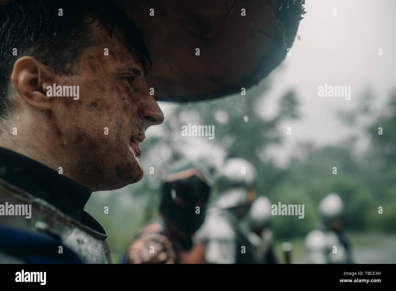 A young man in the image of a medieval knight in armor hides from the ...
