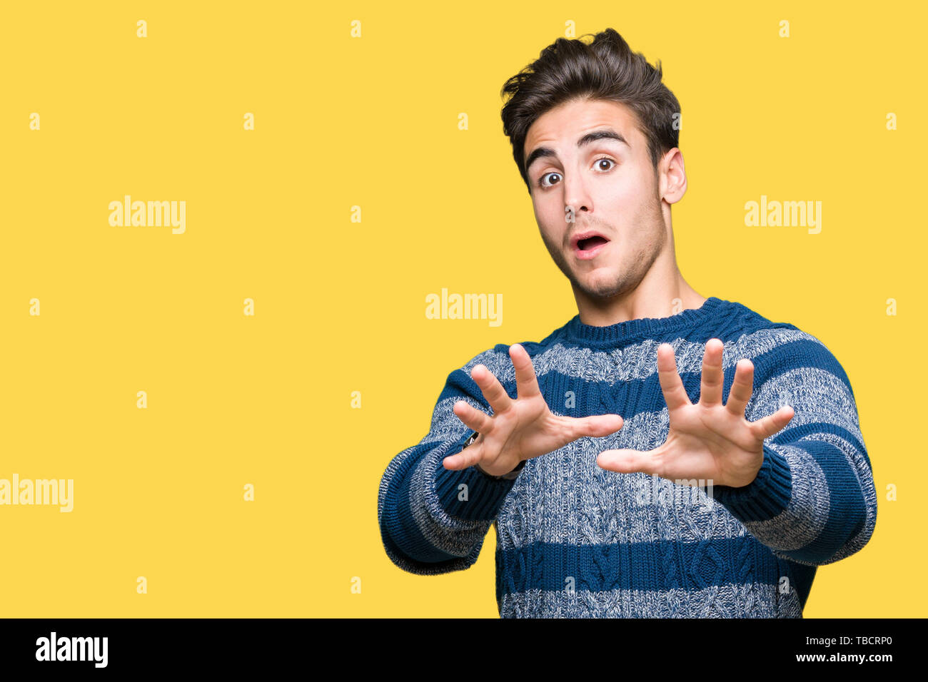 Young handsome man over isolated background afraid and terrified with ...