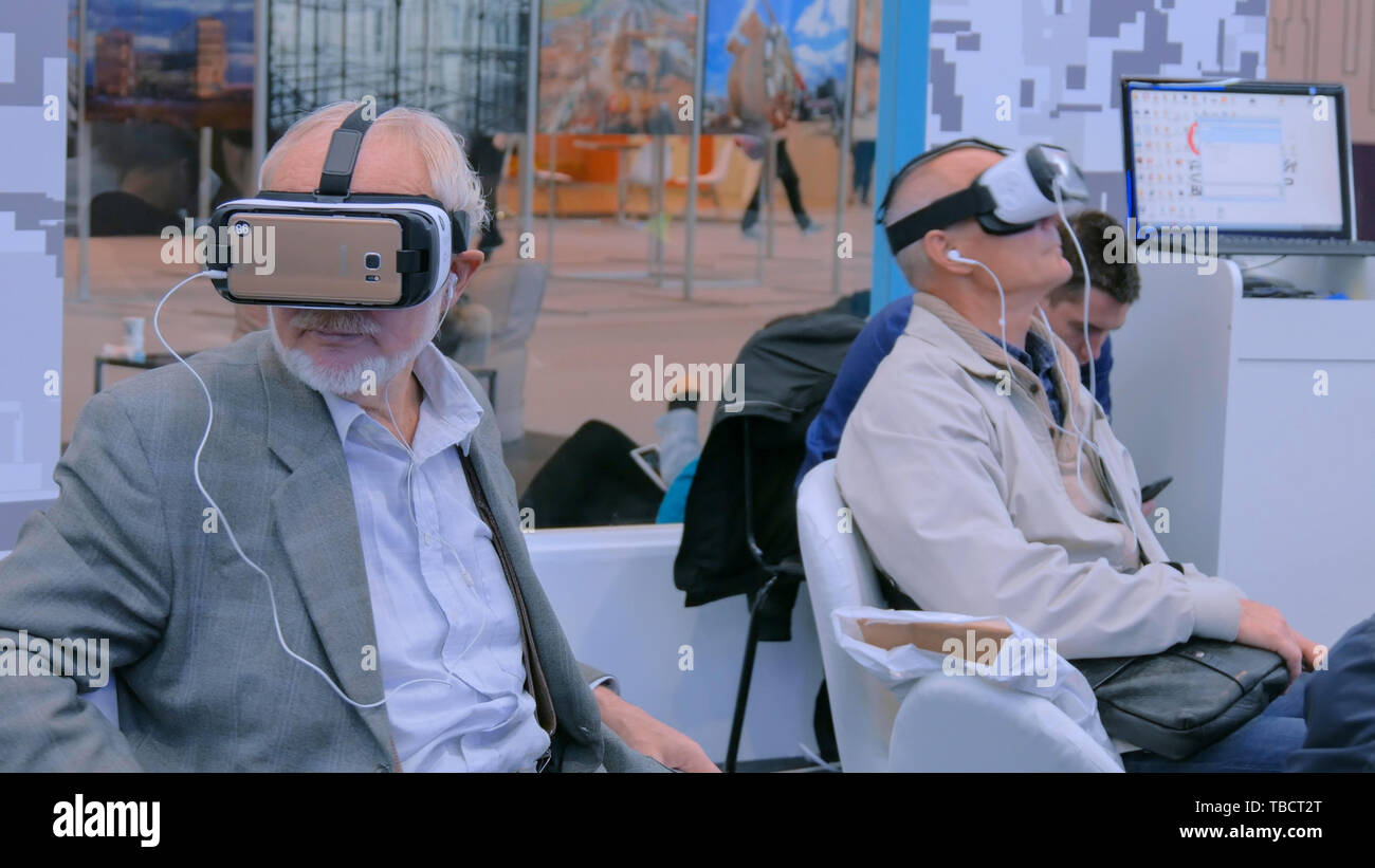 Senior people using virtual reality headset Stock Photo - Alamy