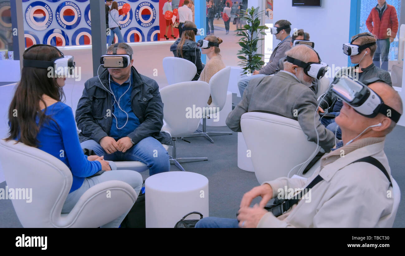Group of people using virtual reality headset at technology show Stock ...