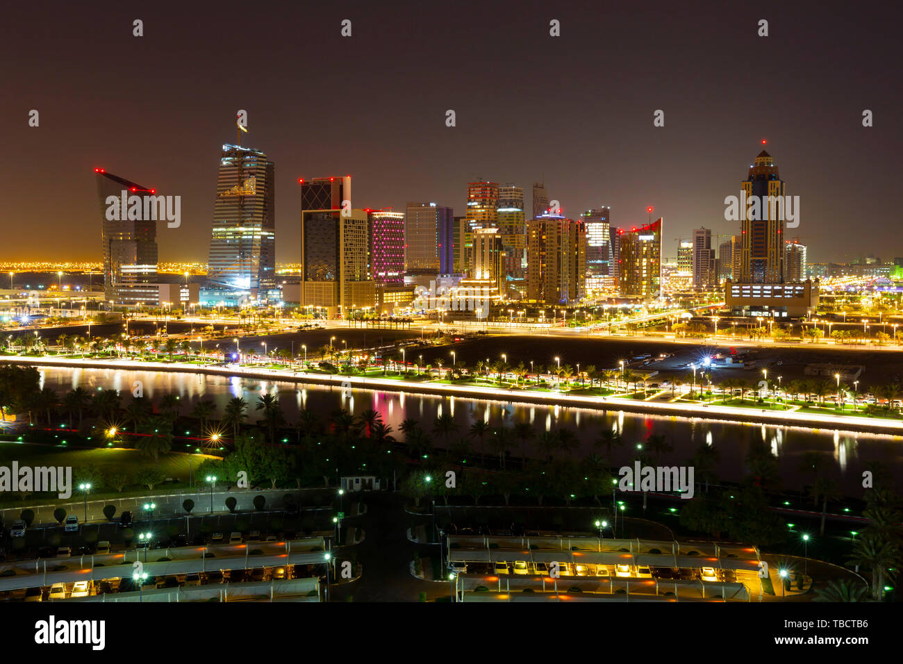 Aerial view of illuminated buildings and streets of Doha, Qatar during ...