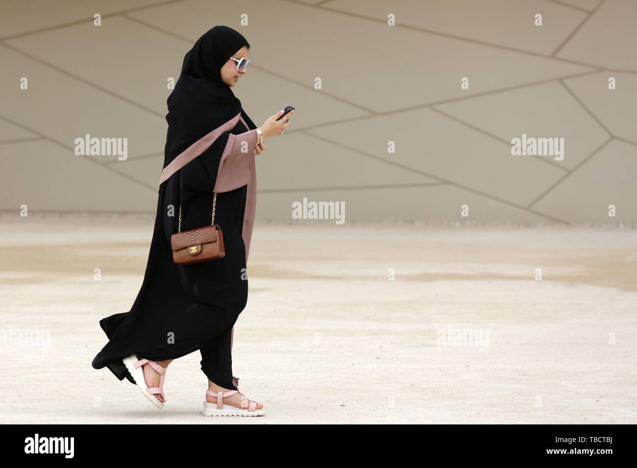 Doha, Qatar - 11 April, 2019: A Qatari woman in a long black dress ...