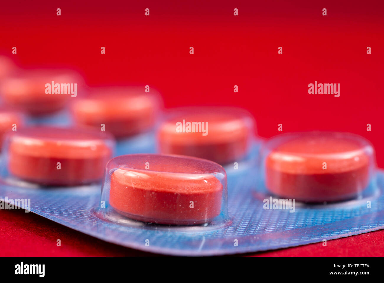 Red pills in blue plastic pack - blister. Global pharmaceutical ...