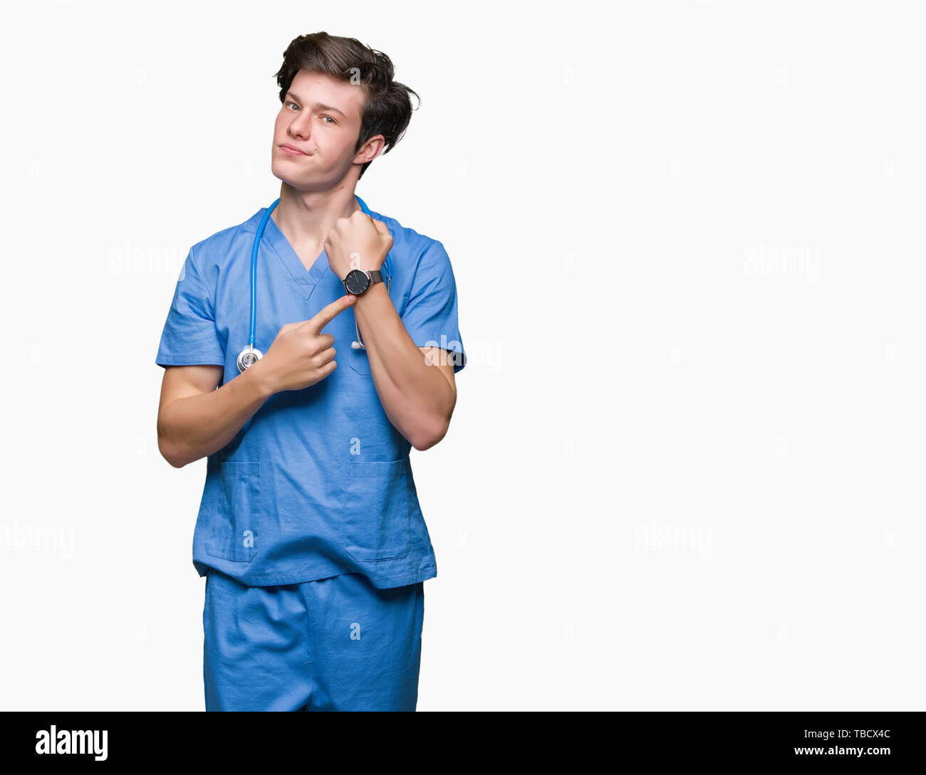 Young doctor wearing medical uniform over isolated background In hurry ...