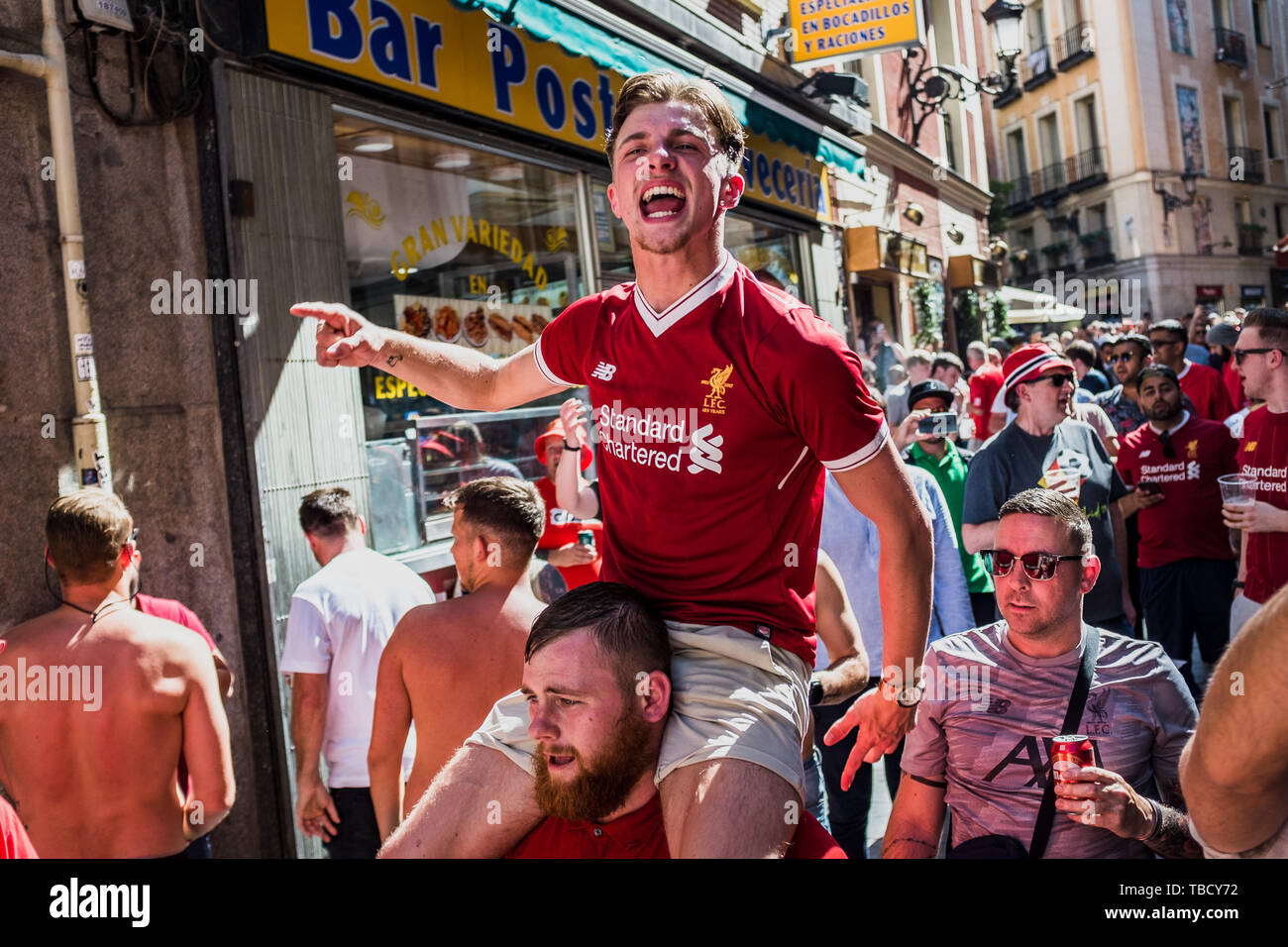 A Liverpool supporter sings and cheers on the streets ahead of the ...