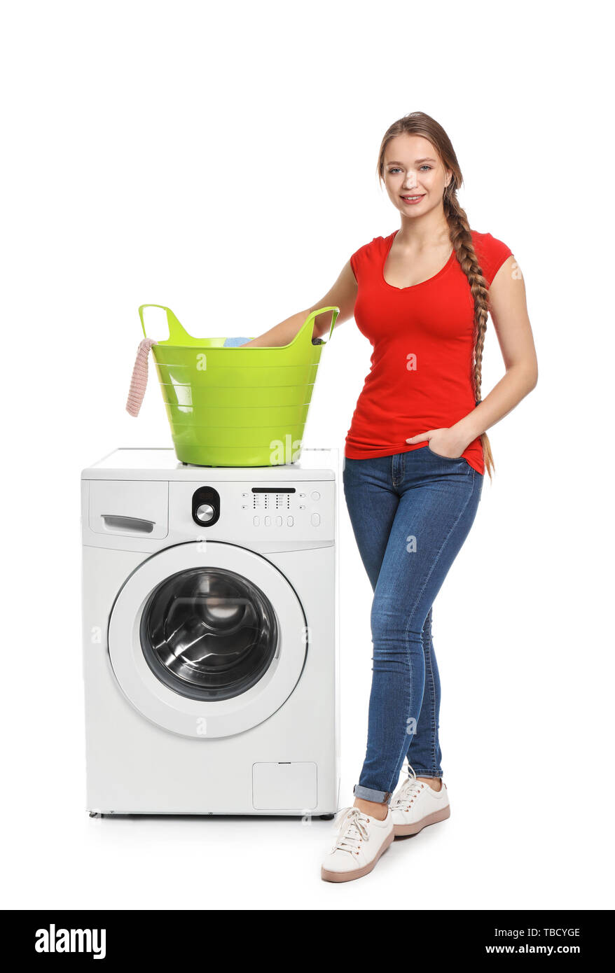 Young woman with washing machine on white background Stock Photo - Alamy