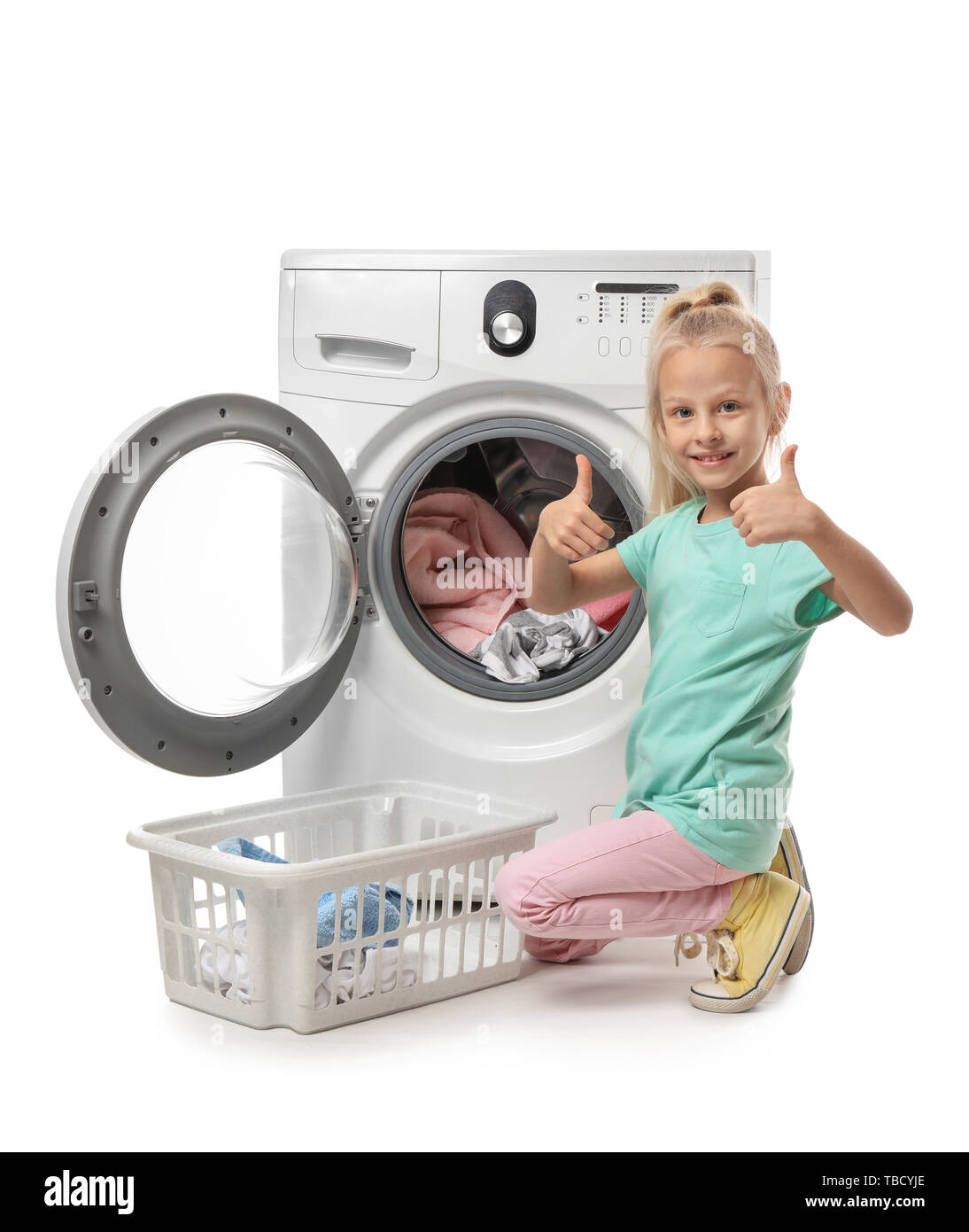 Cute little girl doing laundry on white background Stock Photo - Alamy