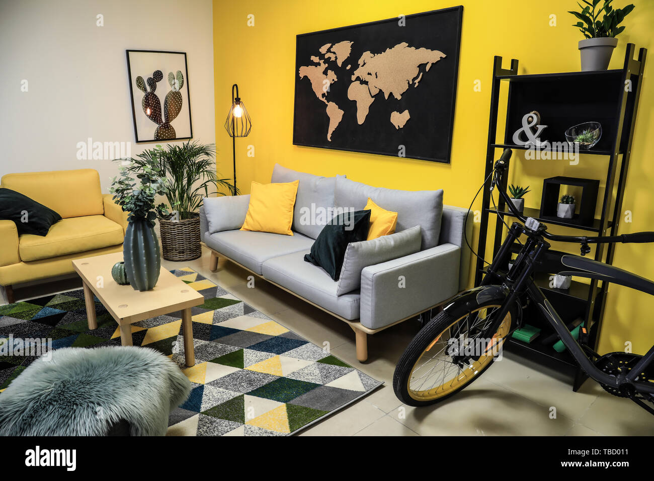 Stylish interior of room with picture of map on wall Stock Photo - Alamy