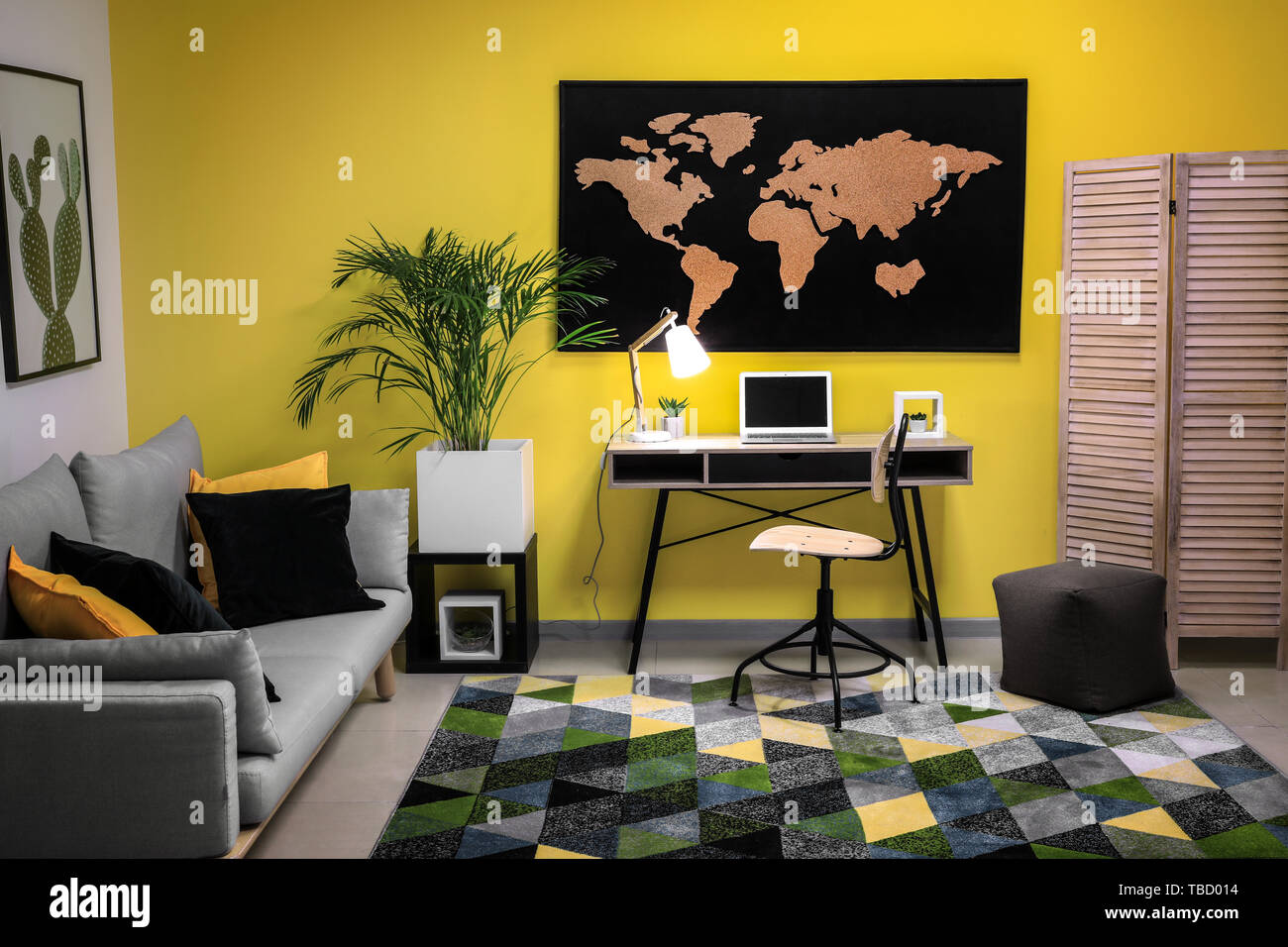 Stylish interior of room with picture of map on wall Stock Photo - Alamy