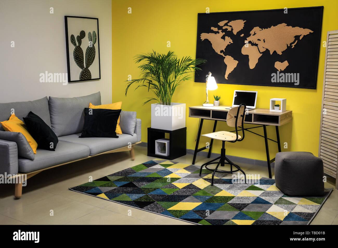 Stylish interior of room with picture of map on wall Stock Photo - Alamy