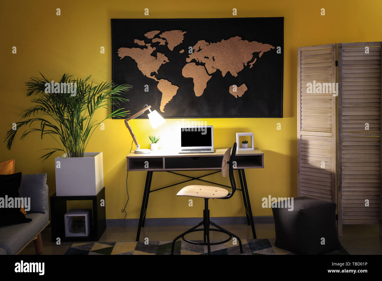 Stylish interior of room with picture of map on wall Stock Photo - Alamy