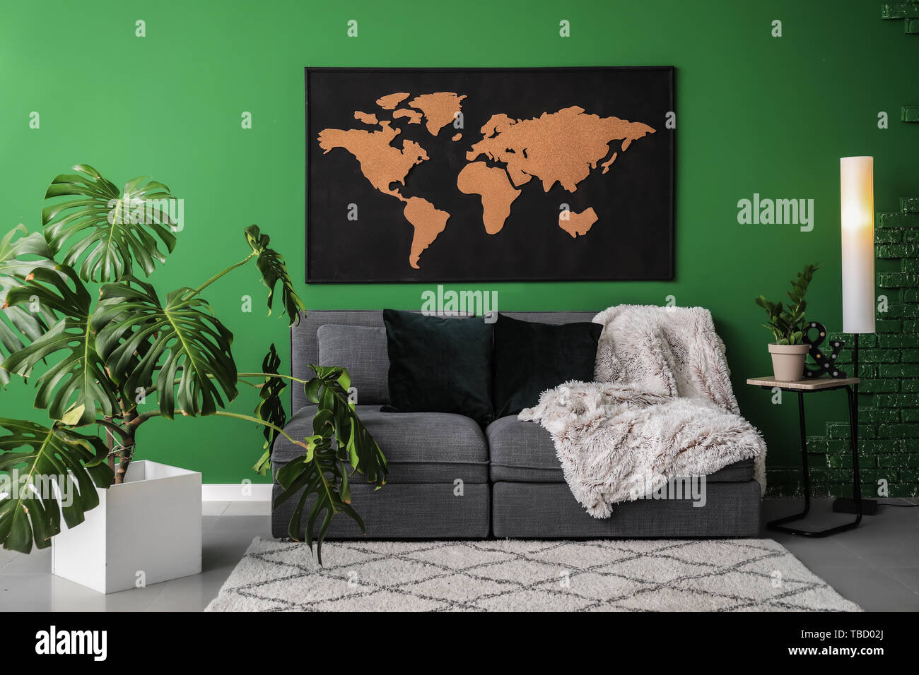 Stylish interior of room with picture of map on wall Stock Photo - Alamy