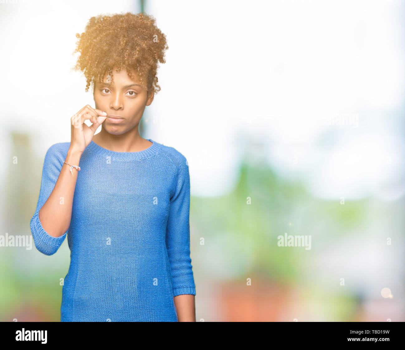 Beautiful young african american woman over isolated background mouth ...