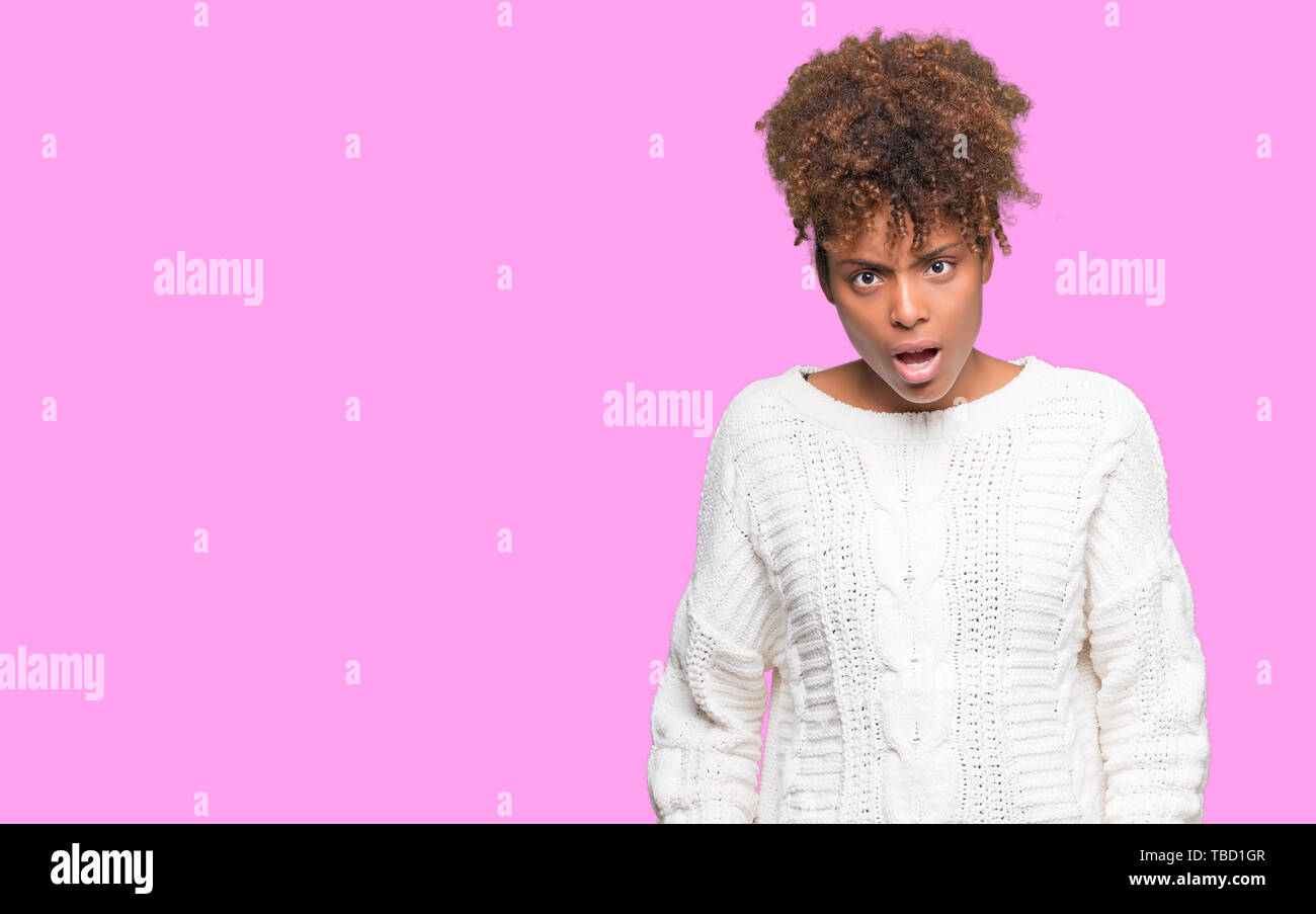 Beautiful young african american woman wearing winter sweater over ...