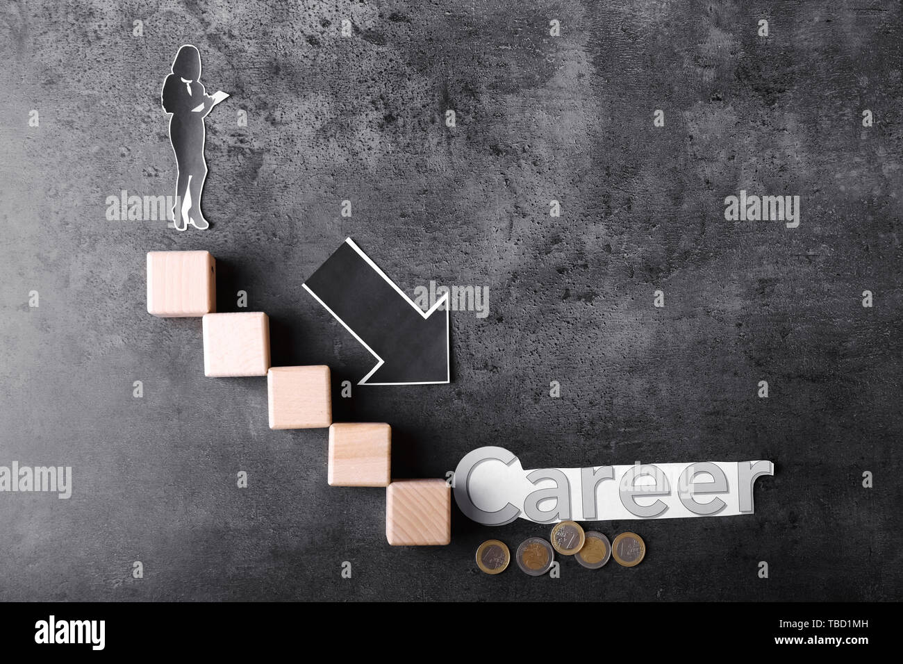 Composition with paper human figure, career ladder and arrow directed ...