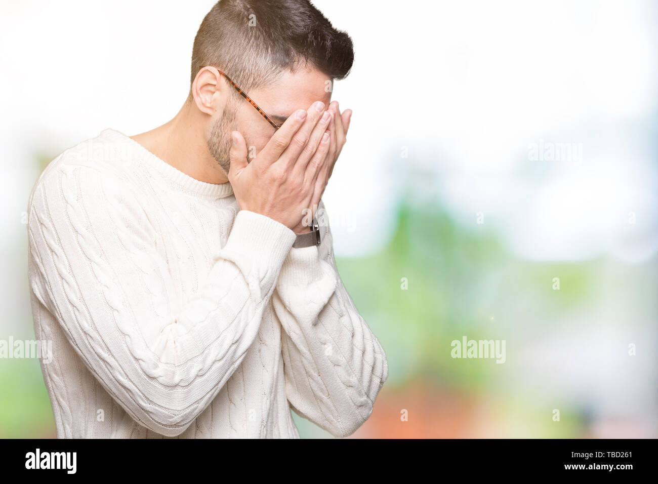 Young handsome man wearing glasses over isolated background with sad ...