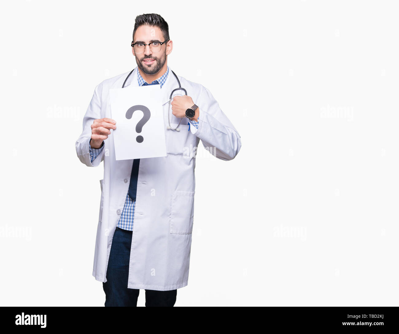 Handsome young doctor man holding paper with question mark over ...